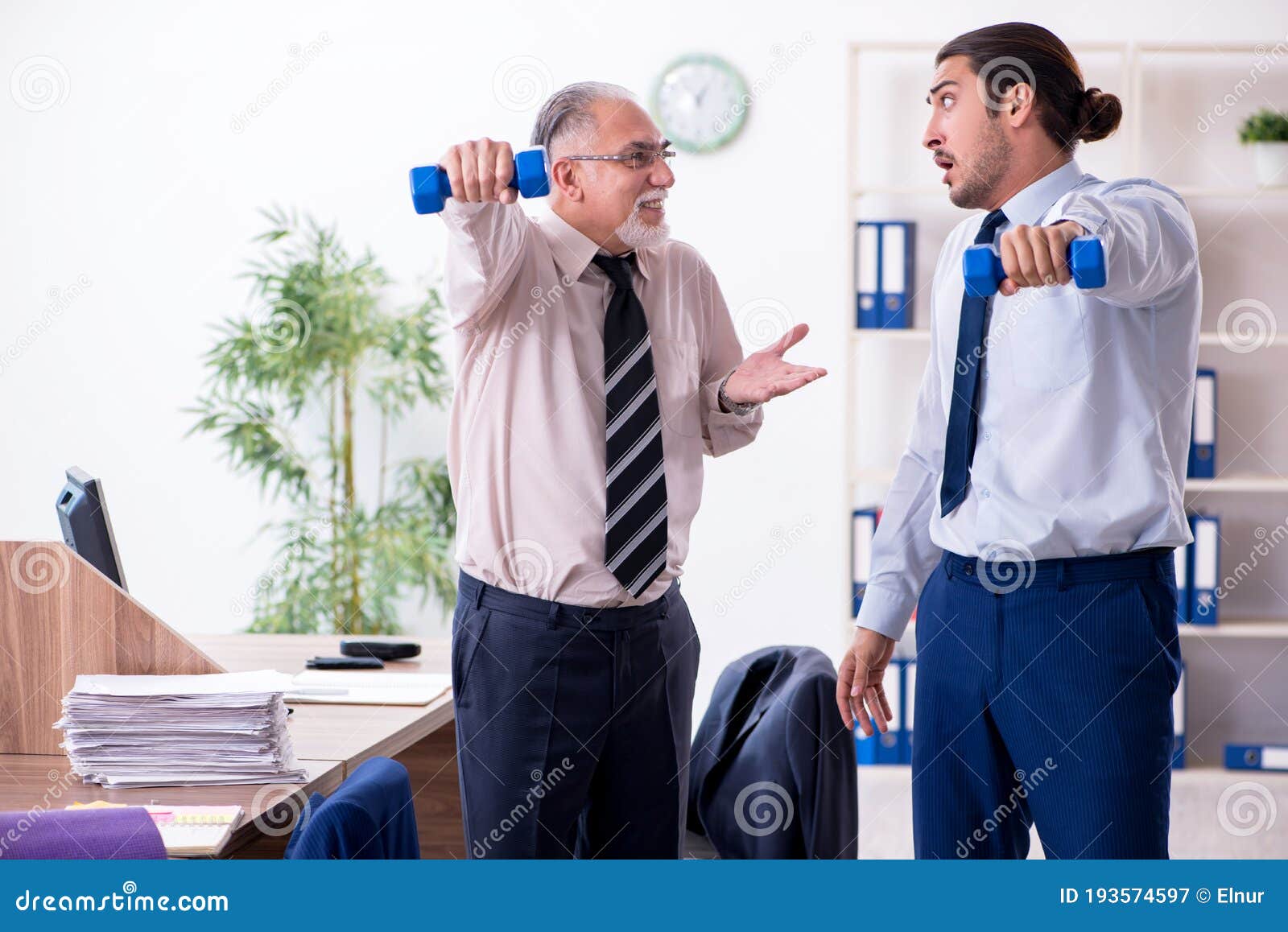 Two Employees Doing Physical Exercises at Workplace Stock Image - Image ...