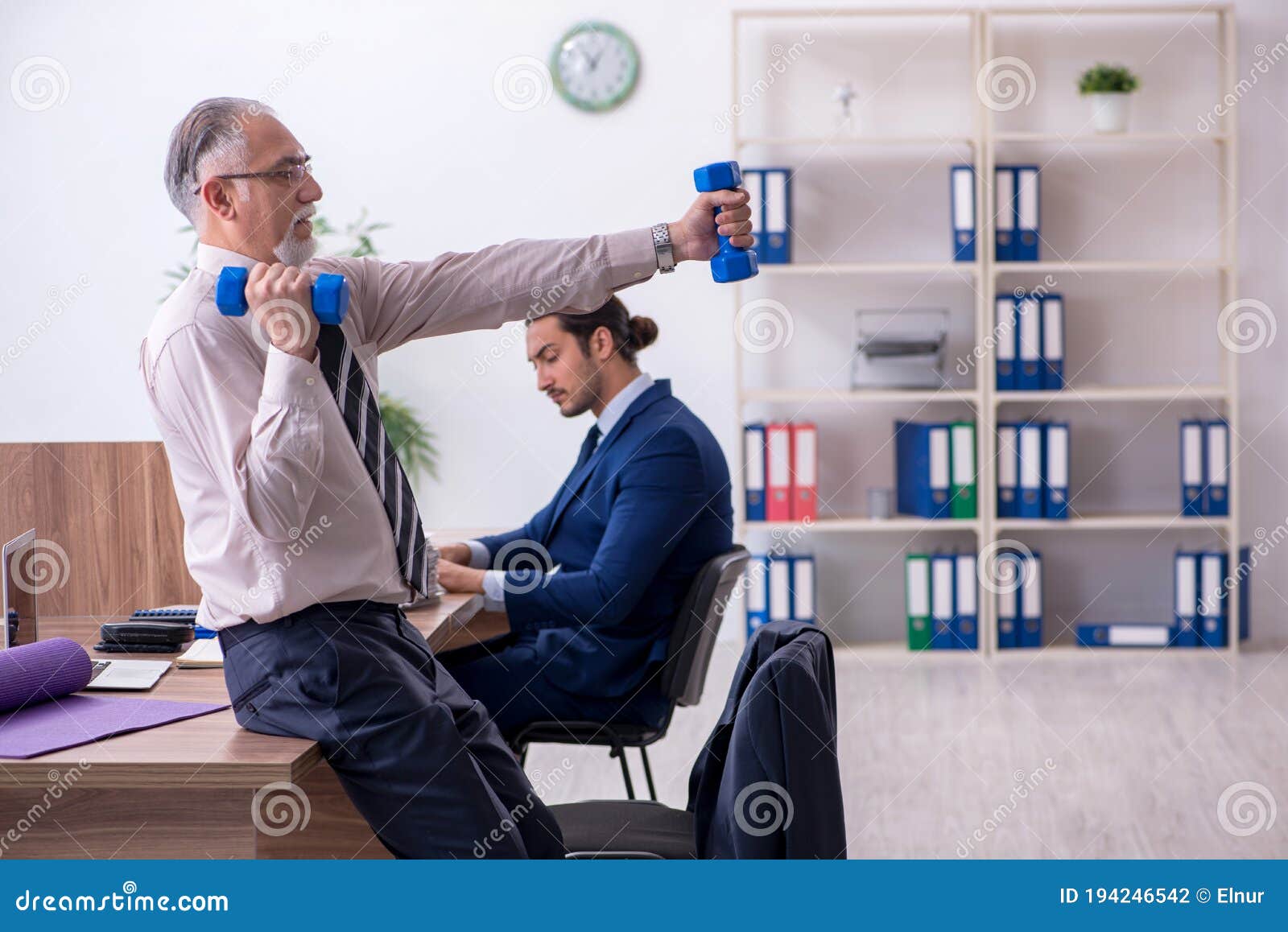 Two Employees Doing Physical Exercises at Workplace Stock Photo - Image ...