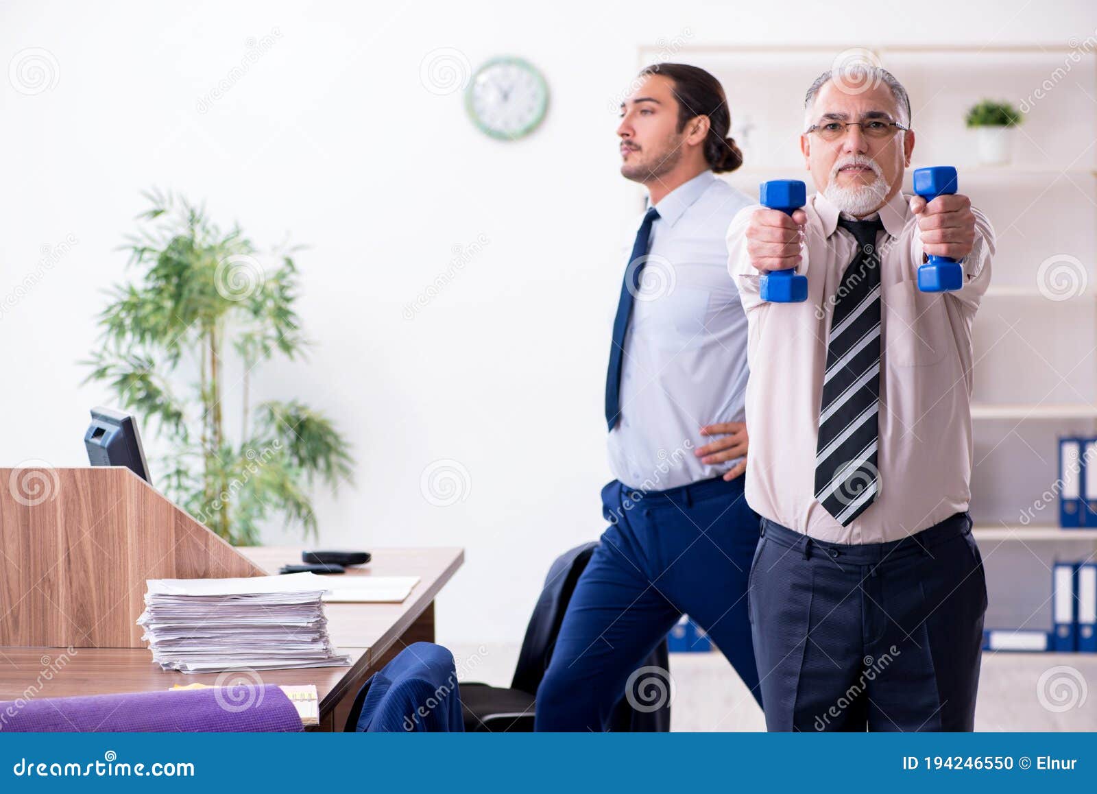 Two Employees Doing Physical Exercises at Workplace Stock Photo - Image ...