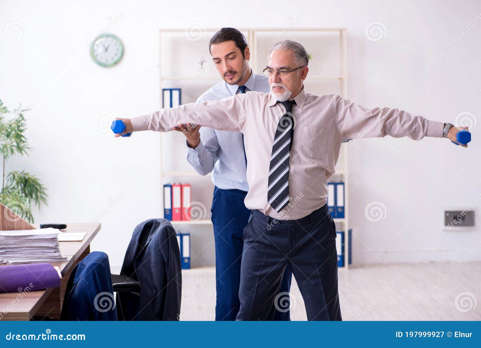 Two Employees Doing Physical Exercises at Workplace Stock Image - Image ...