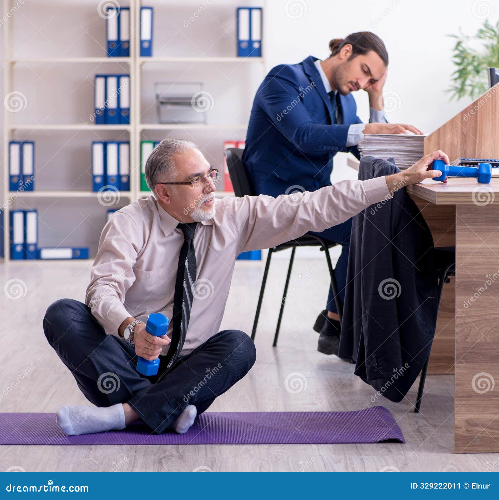 Two Employees Doing Physical Exercises at Workplace Stock Image - Image ...