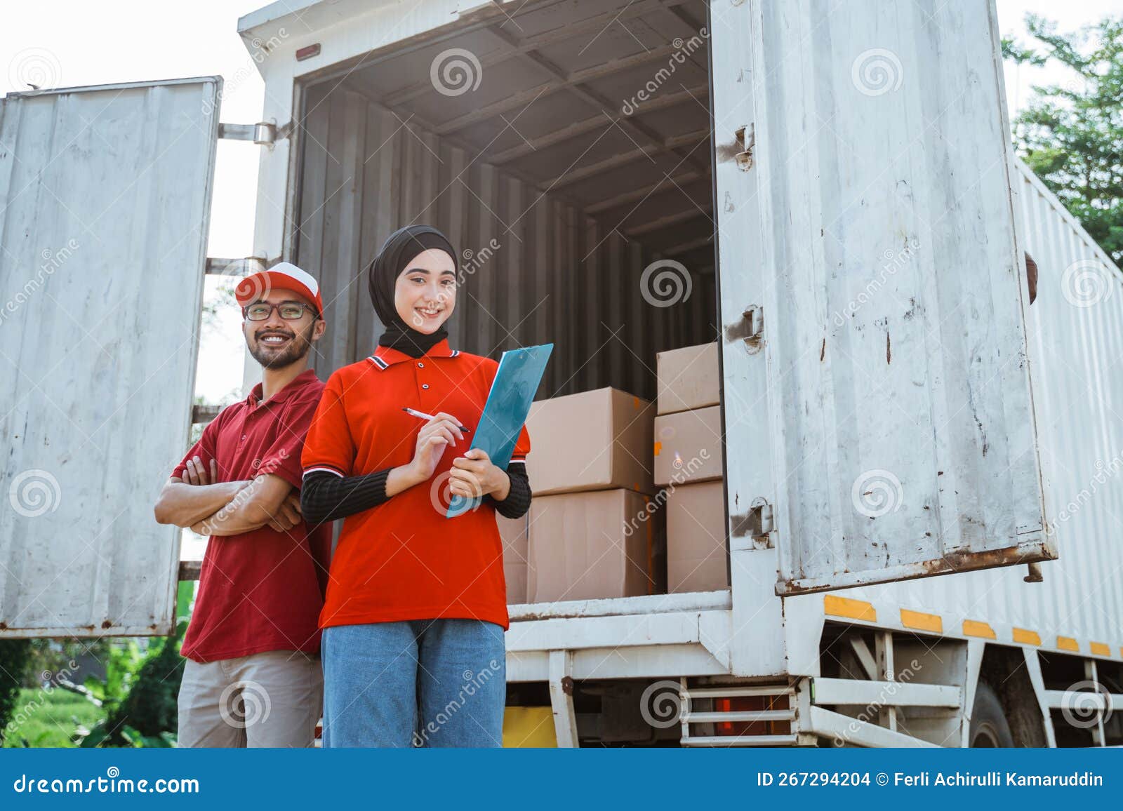 Two Employees in Red Uniforms Behind a Logistics Container Truck Stock ...
