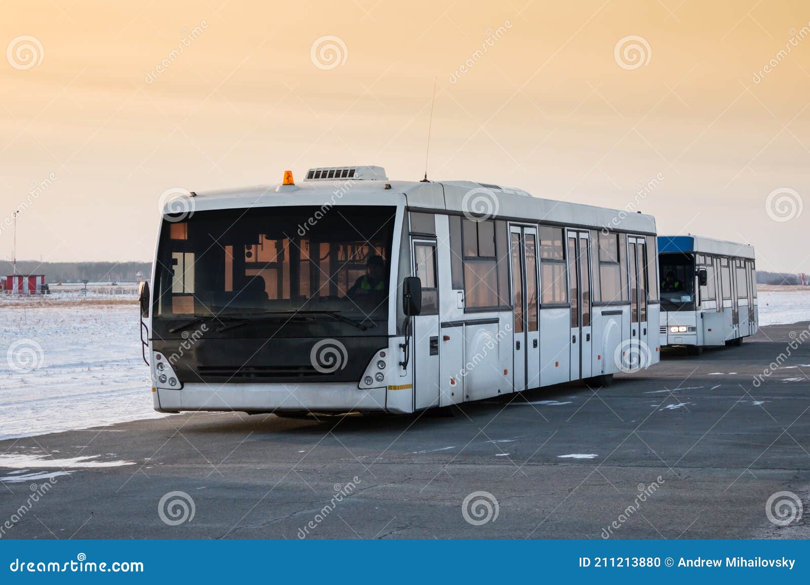 Two Empty Airport Shuttle Buses in a Cold Winter Evening Stock Photo ...