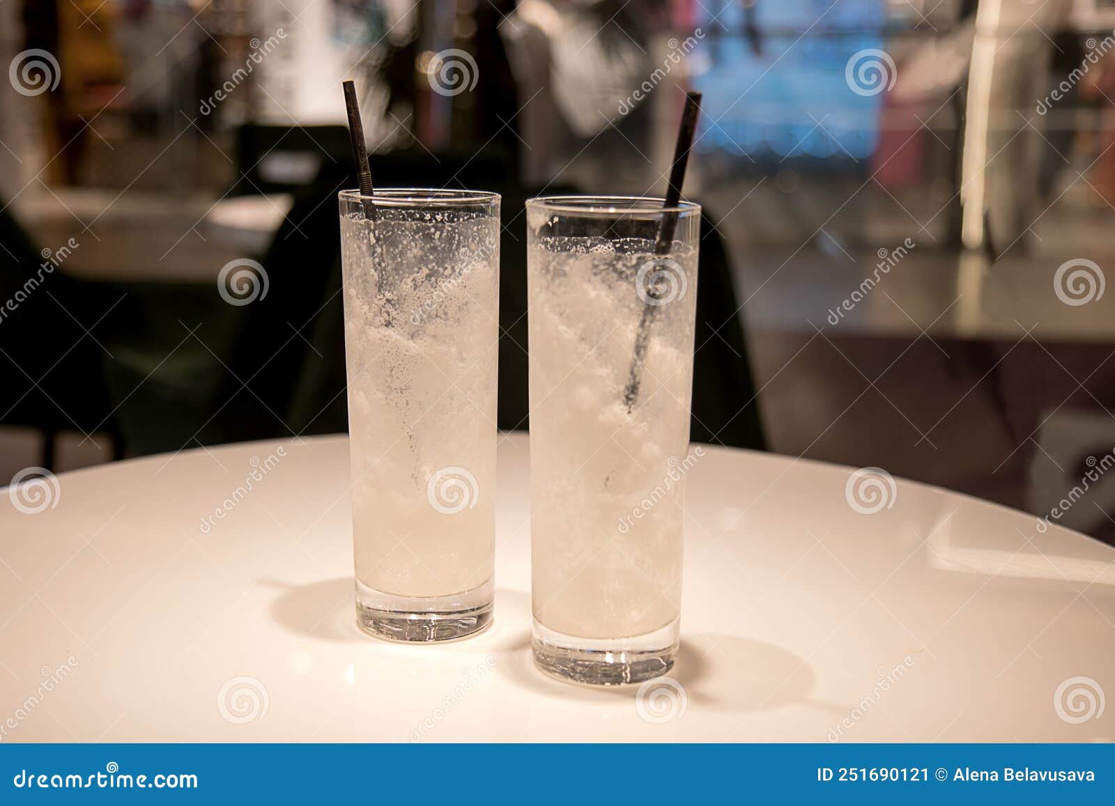 Two Empty Glasses from a Milkshake with Straws on a Table in a Cafe ...