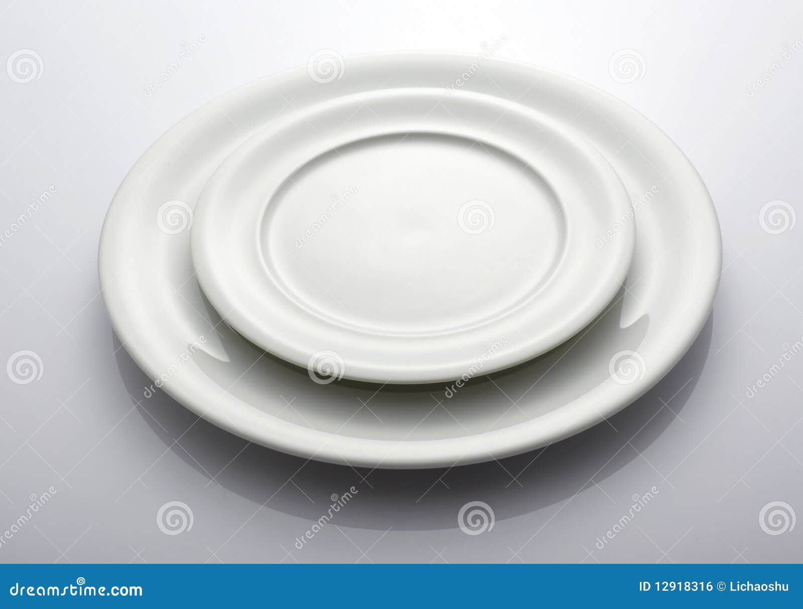 A Set Of White Plates With Porridge And Blueberry Jam Leftovers ...