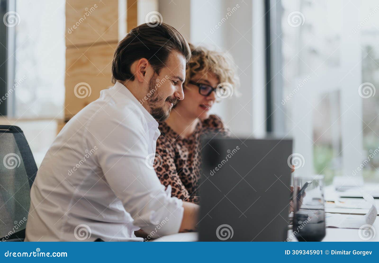 Focused, Different Aged, Business Colleagues Collaborating on Project at Workplace with Laptop ...