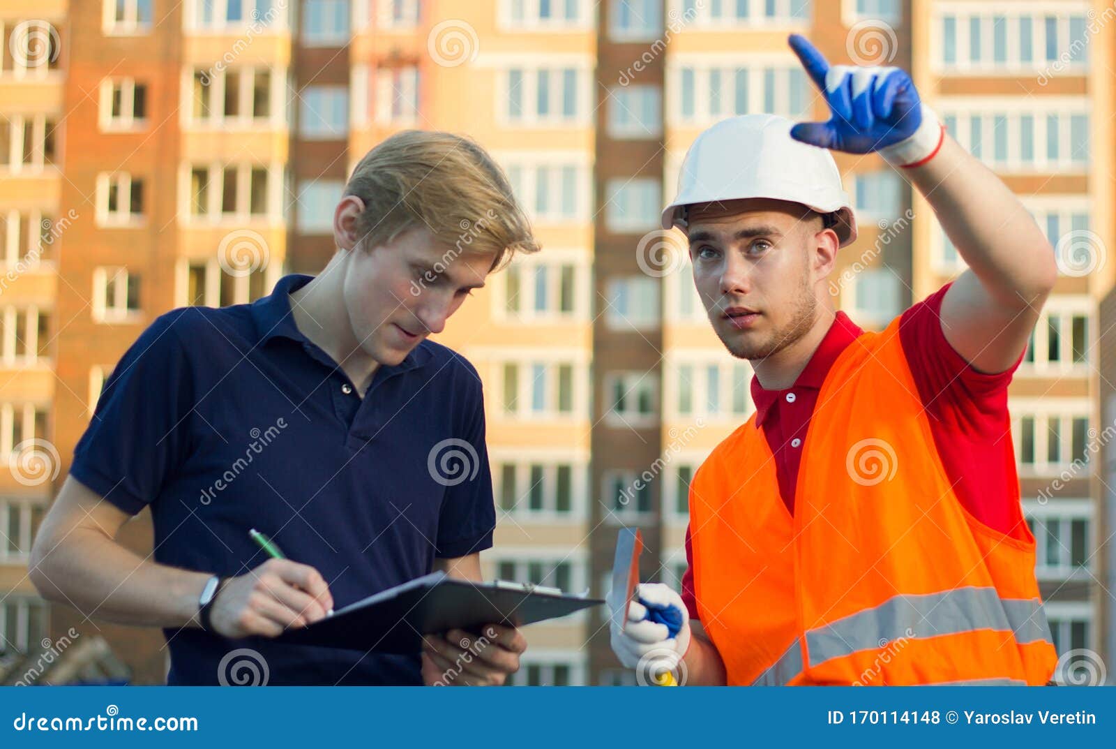 Two Engineer Builders with Blueprint Plan at Construction Site Stock ...