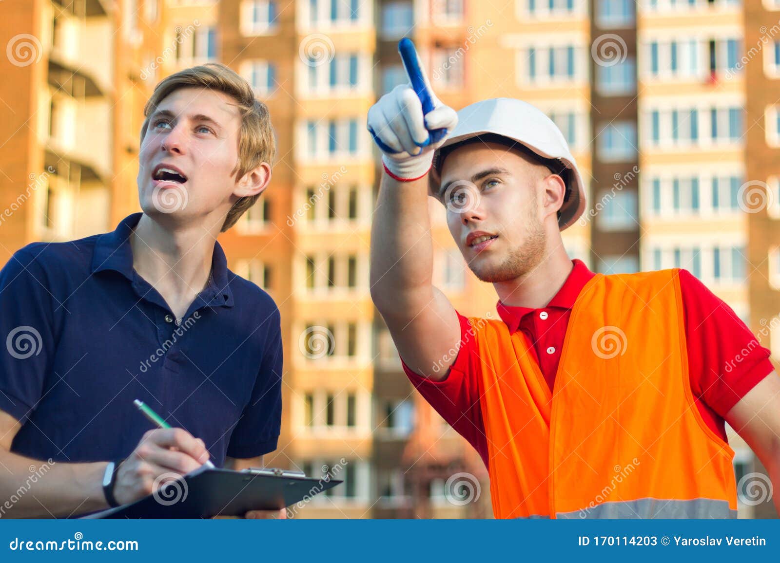 Two Engineer Builders with Blueprint Plan at Construction Site Stock ...