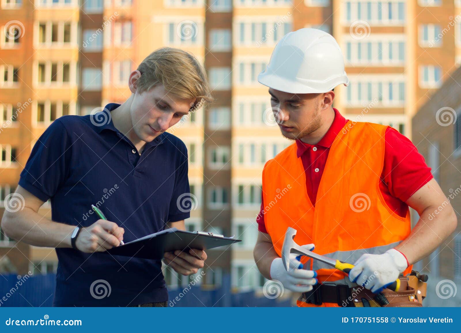 Two Engineer Builders with Blueprint Plan at Construction Site Stock ...