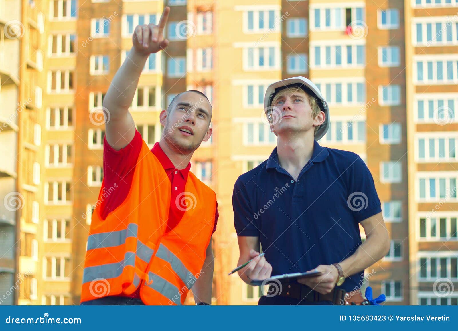 Two Engineer Builders with Blueprint Plan at Construction Site Stock ...