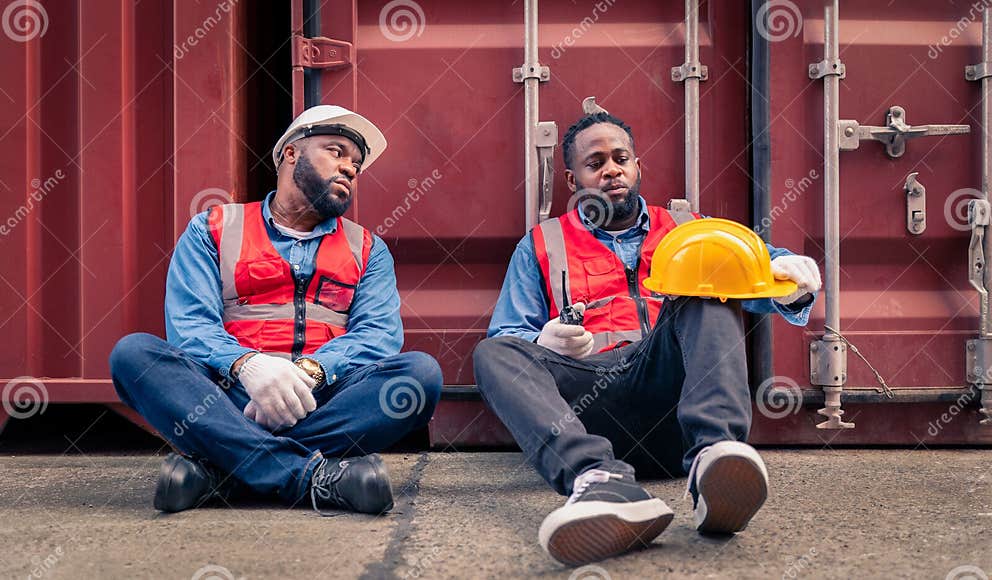 Two Engineer or Foreman Wears PPE Sitting Stress on Container ...