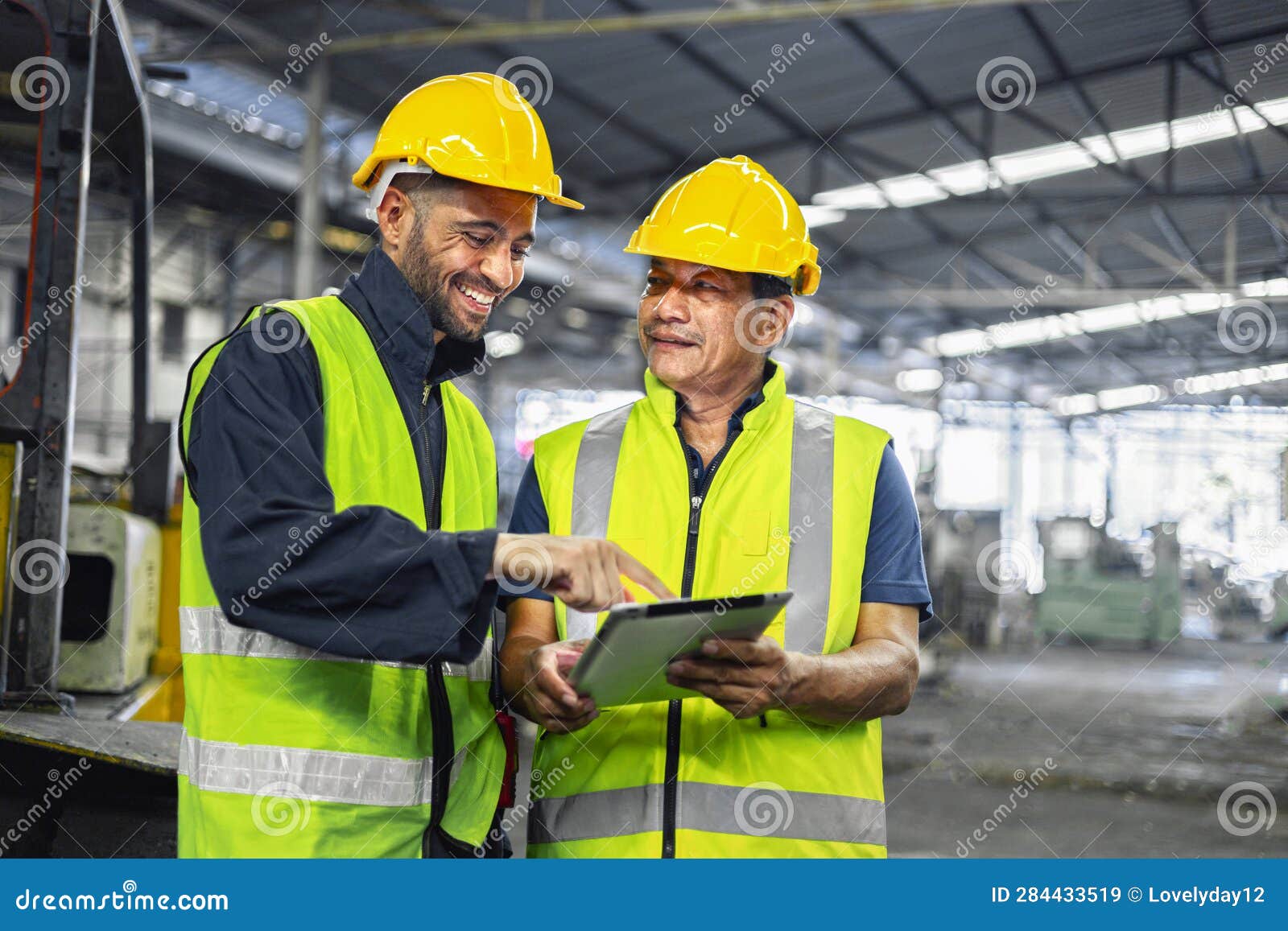 Two Engineer Look Projects and Planning with Tablet Mobile in Factory ...
