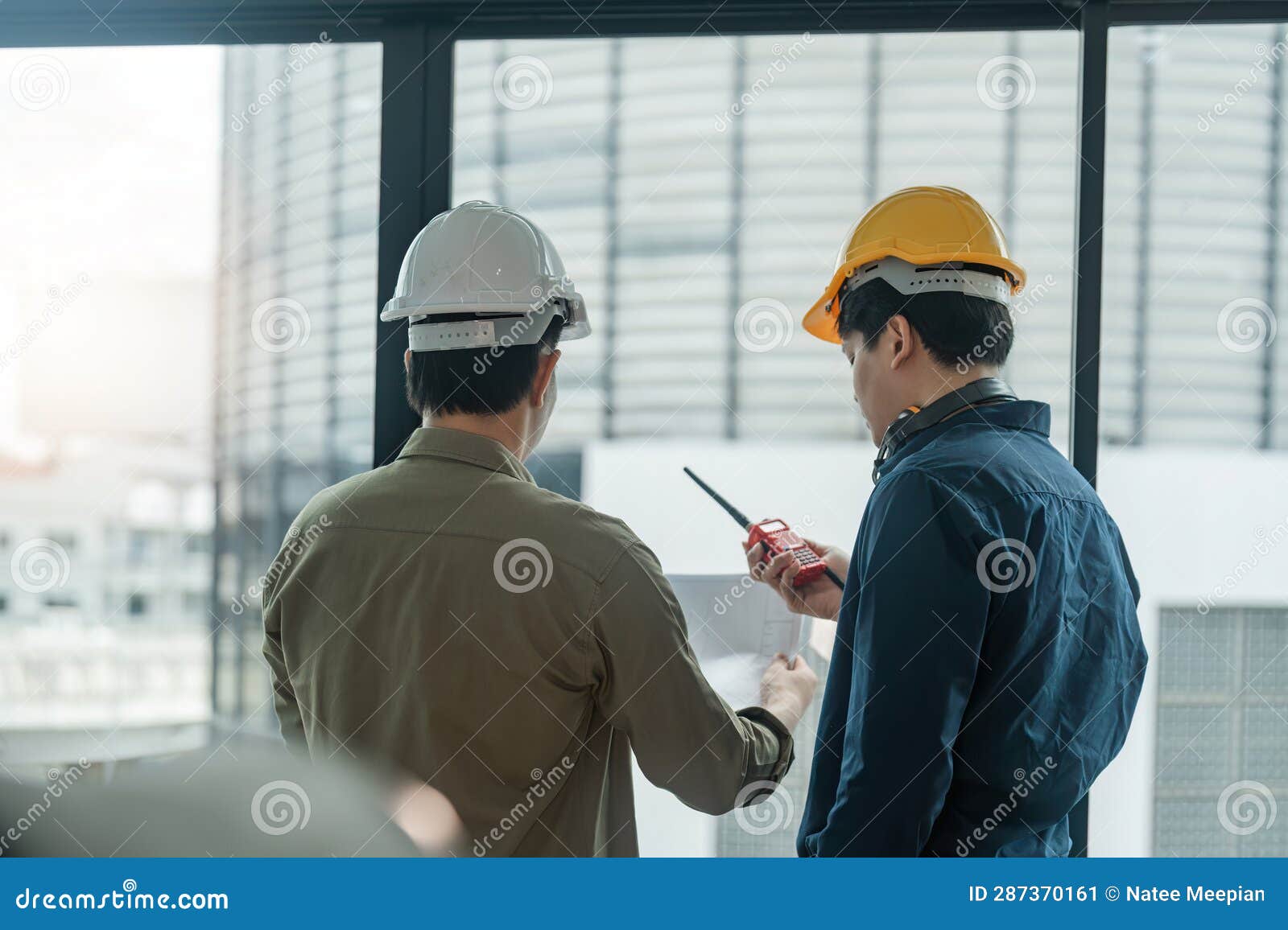 Two Engineer Man Checking Work with Walkie-talkie for Communication in ...