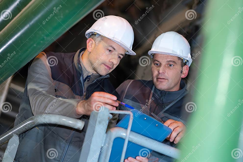 Two Engineer Worker Working Together with Safety Uniform Stock Image ...