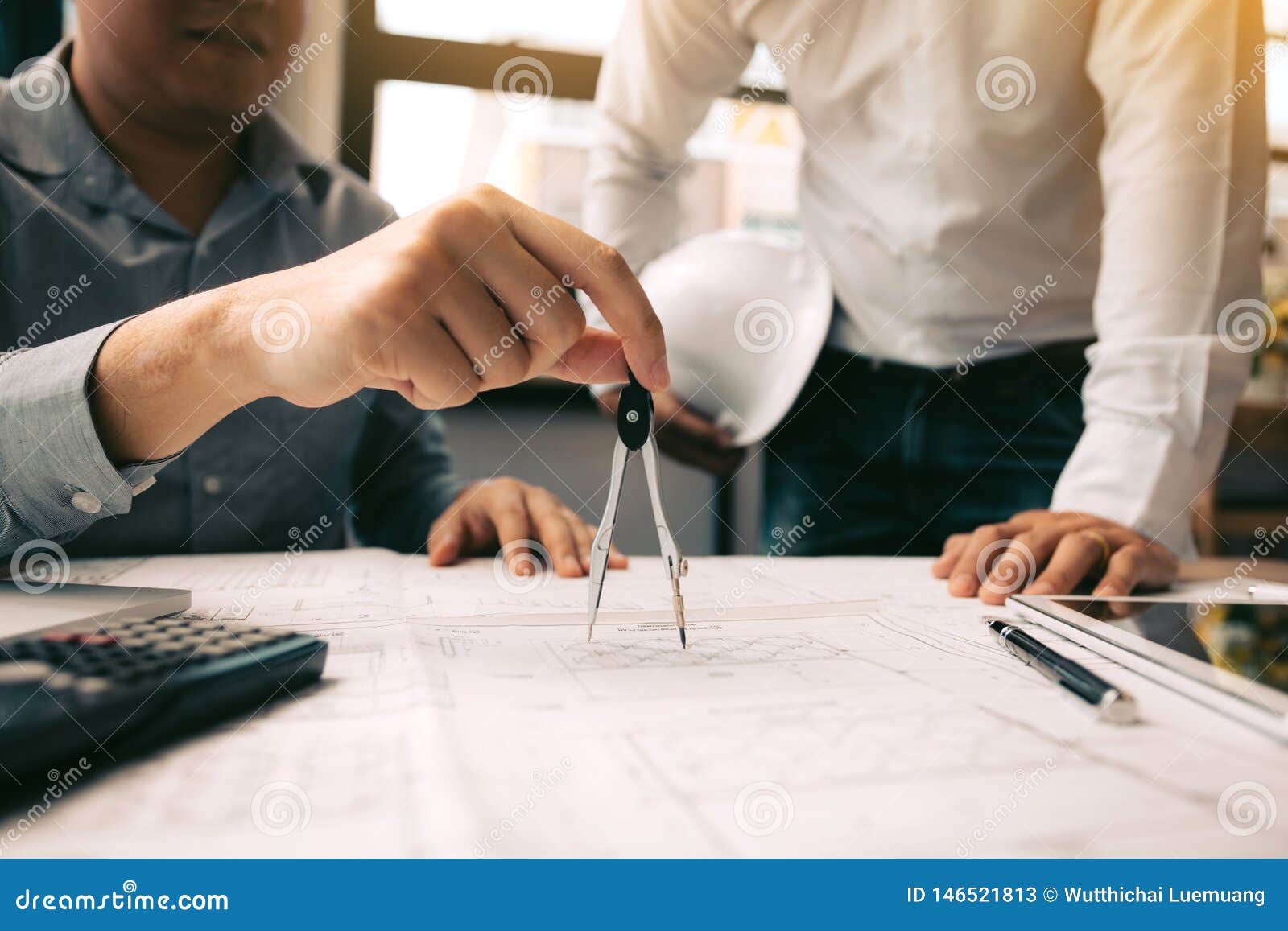 Two Engineering Working Together and Using Digital Tablet Looking ...