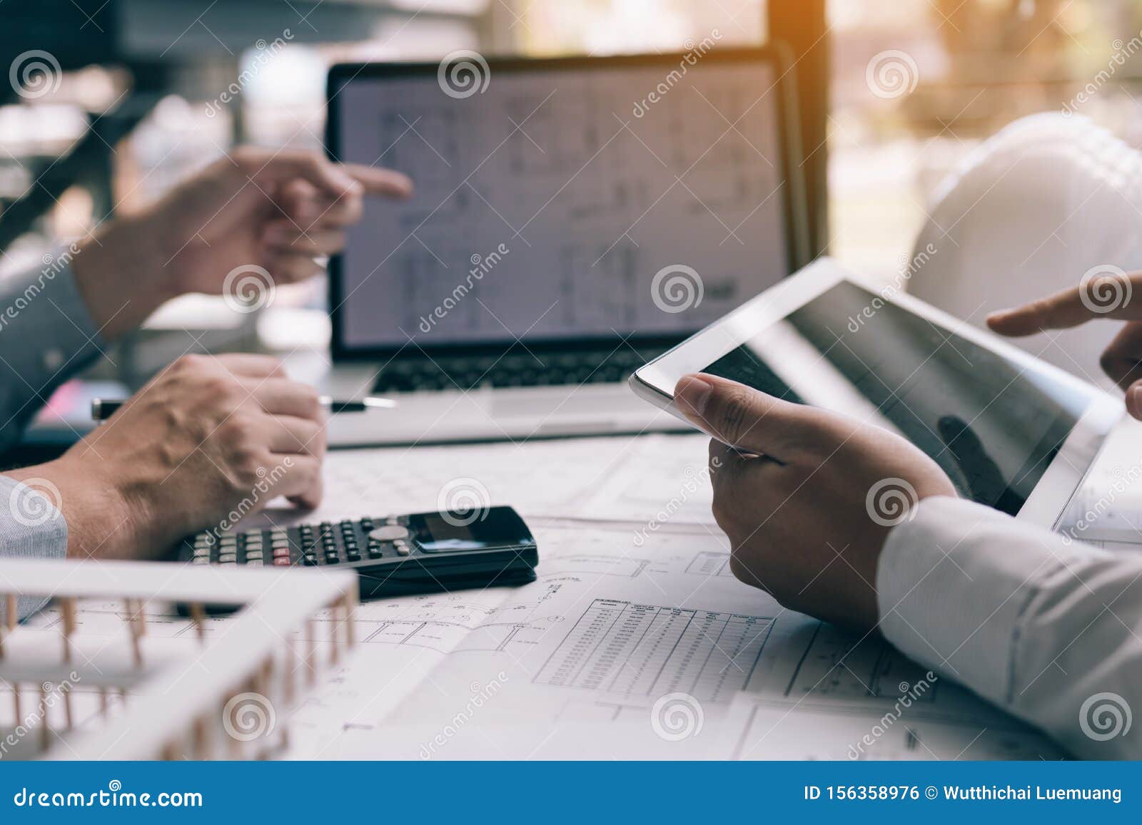 Two Engineering Working Together And Using Compass Looking Blueprint ...