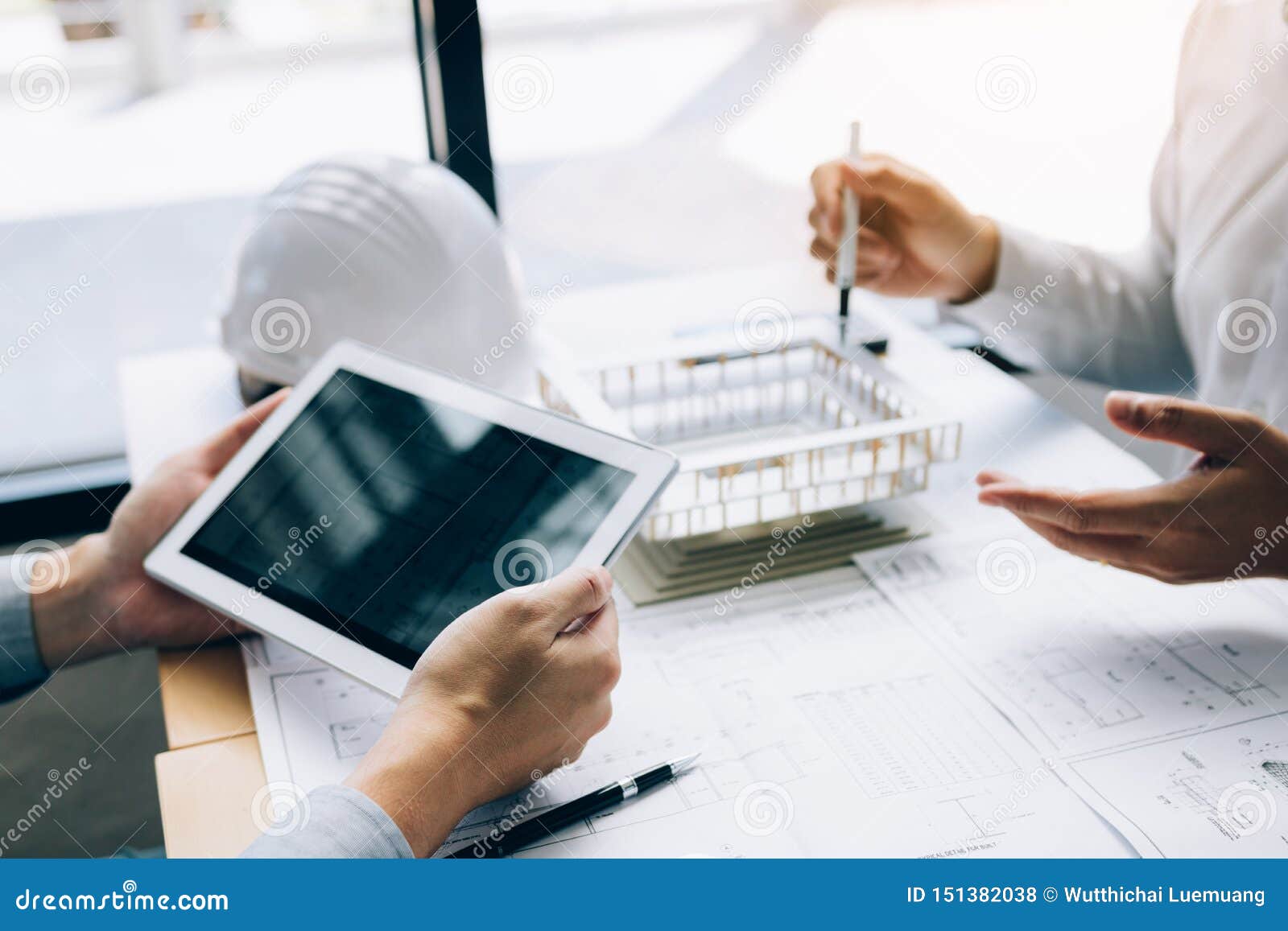 Two Engineering Working Together and Using Digital Tablet Looking ...