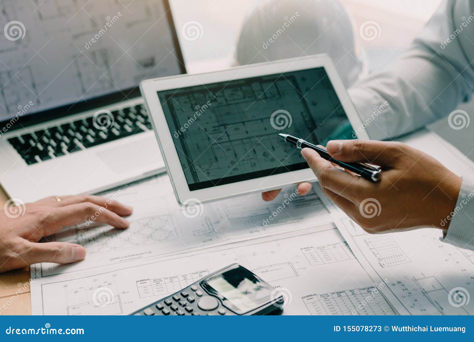 Two Engineering Working Together and Using Digital Tablet Looking ...