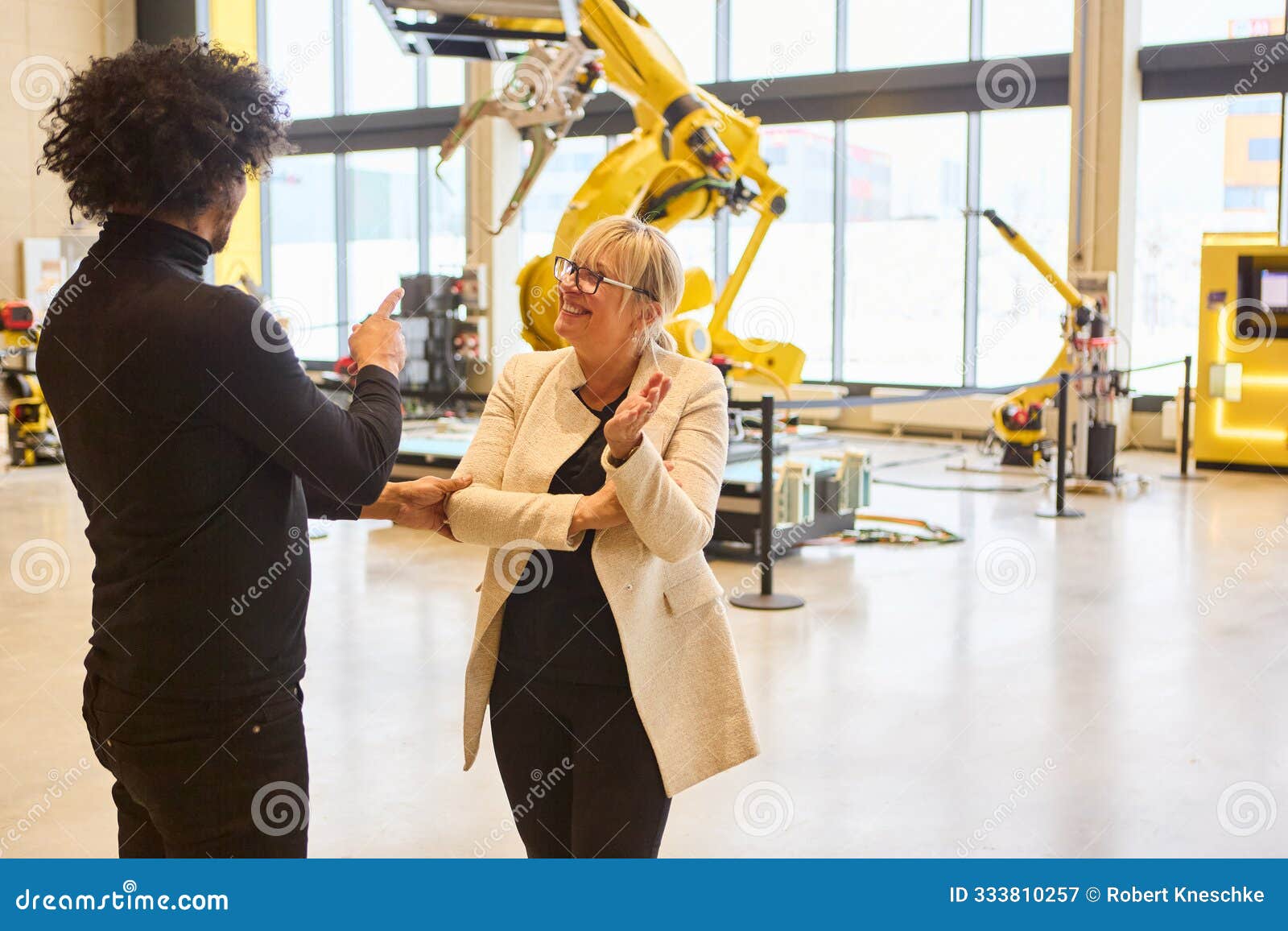 Engineers Discussing Robotics Innovations in a Modern Lab with ...