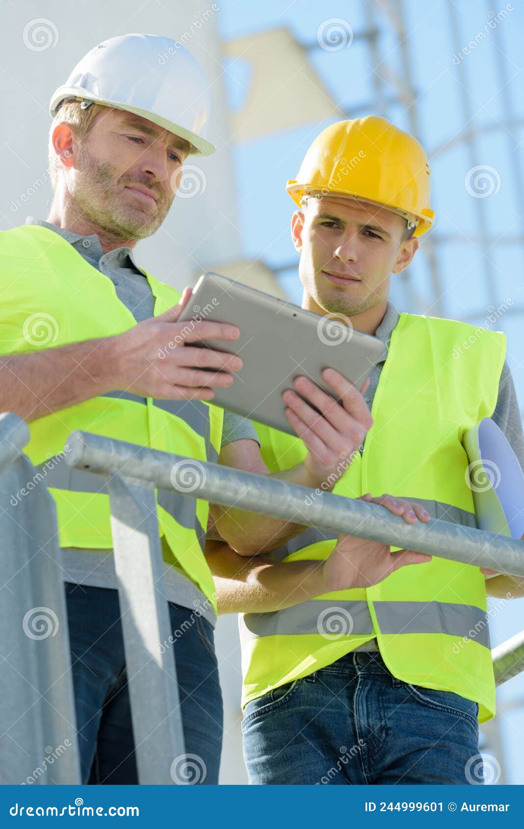 Two Engineers in Hardhat Using Tablet Computer Stock Image - Image of ...