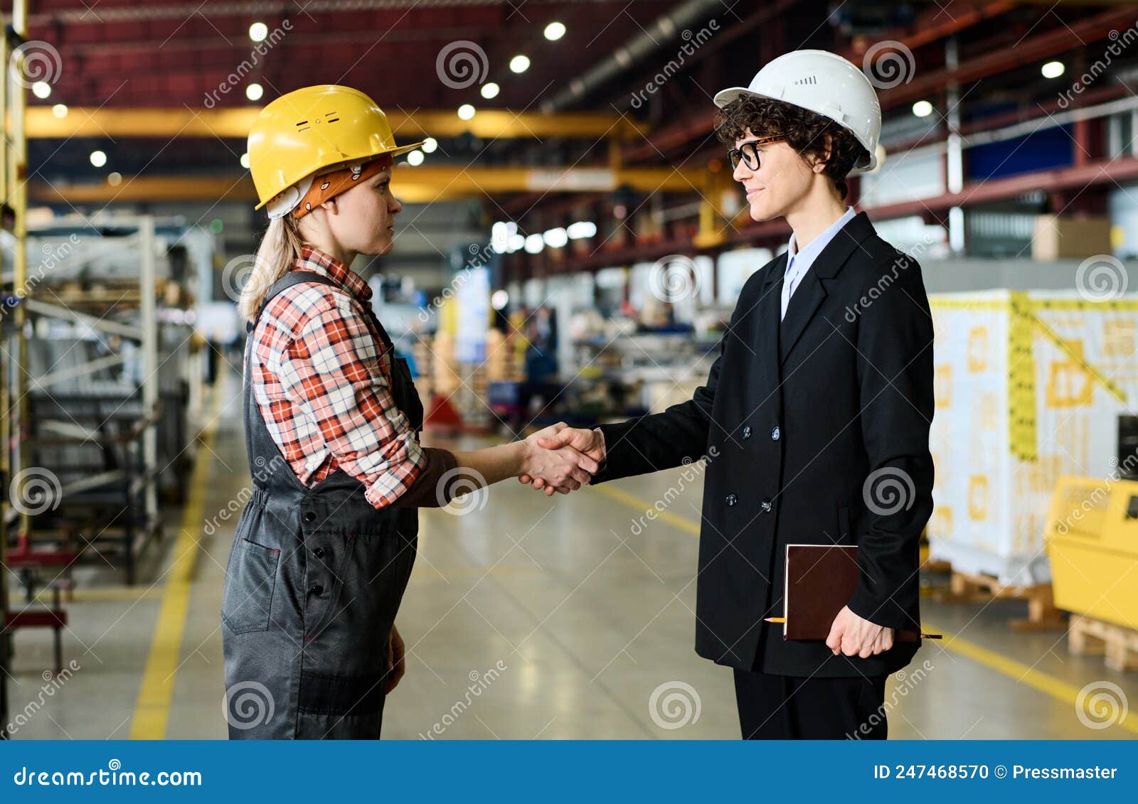 Two Engineers of Large Modern Factory Shaking Hands after Making ...