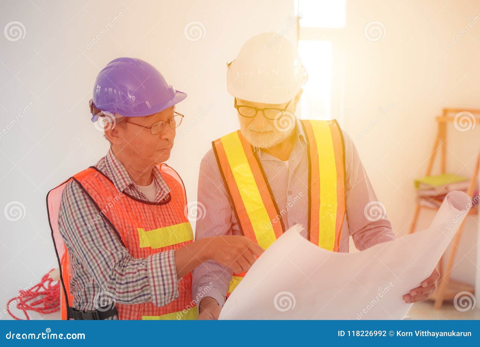 Two Engineers Looking at Blueprint Stock Photo - Image of builder ...