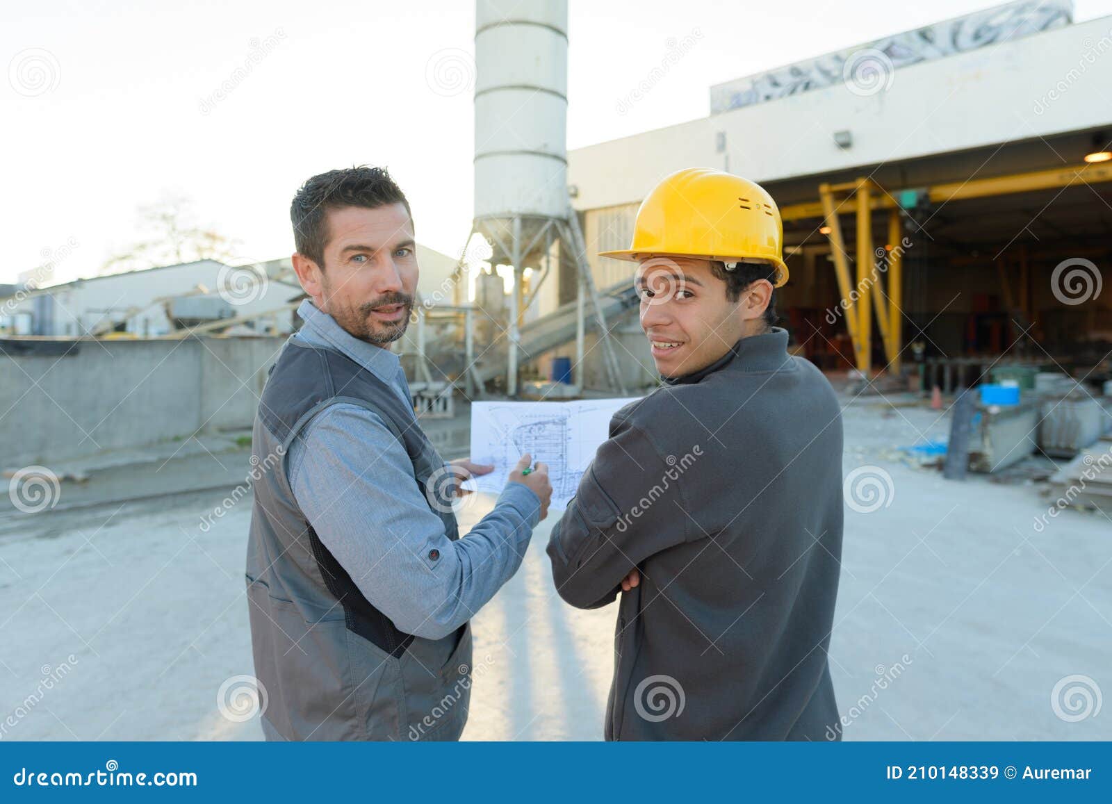 Two Engineers Looking at Camera at Plant Site Stock Image - Image of ...
