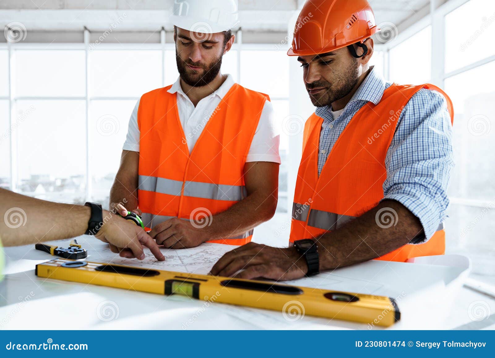 Two Engineers Man Looking at Project Plan on the Table in Construction ...