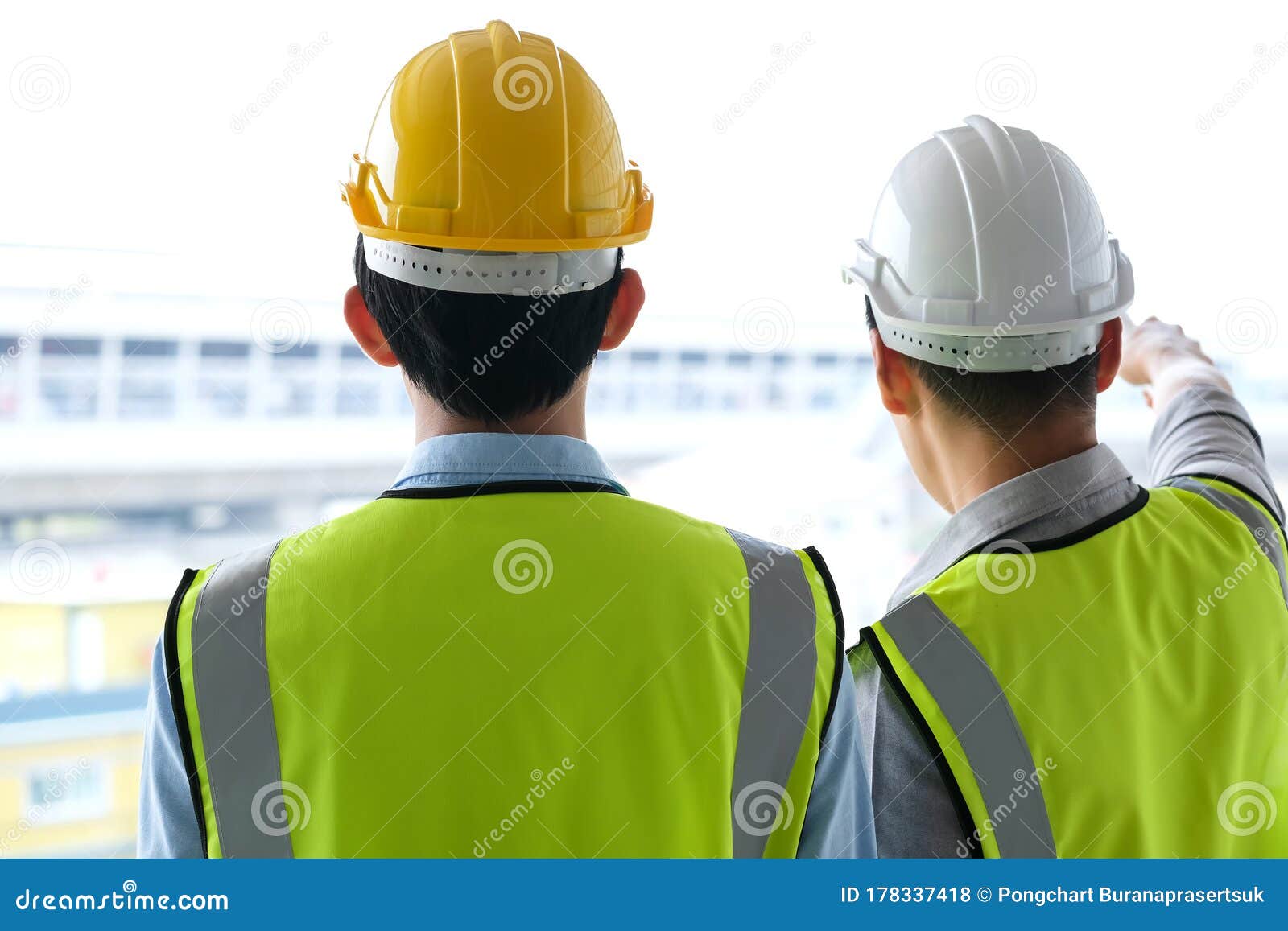 Two Engineers Man Standing in Front of the Site. Right Engineer Holding ...