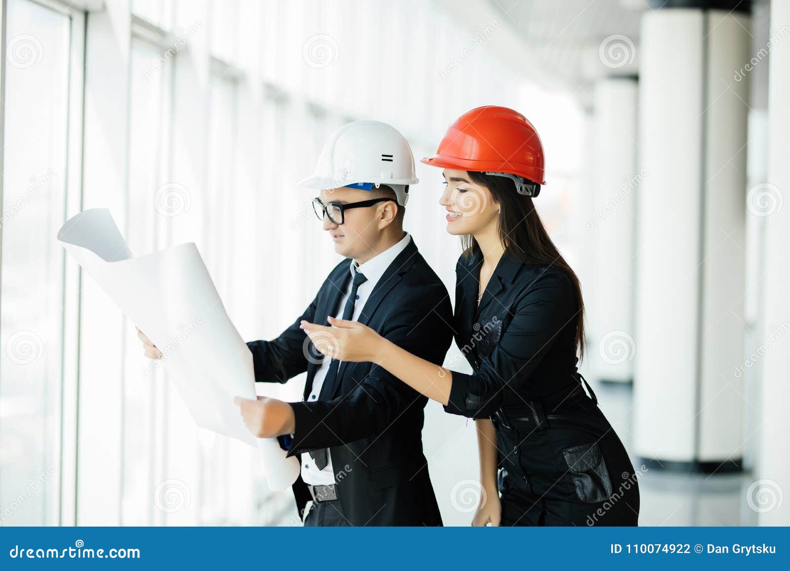 The Two Engineers Stand Near the Panoramic Window and Gesture on ...
