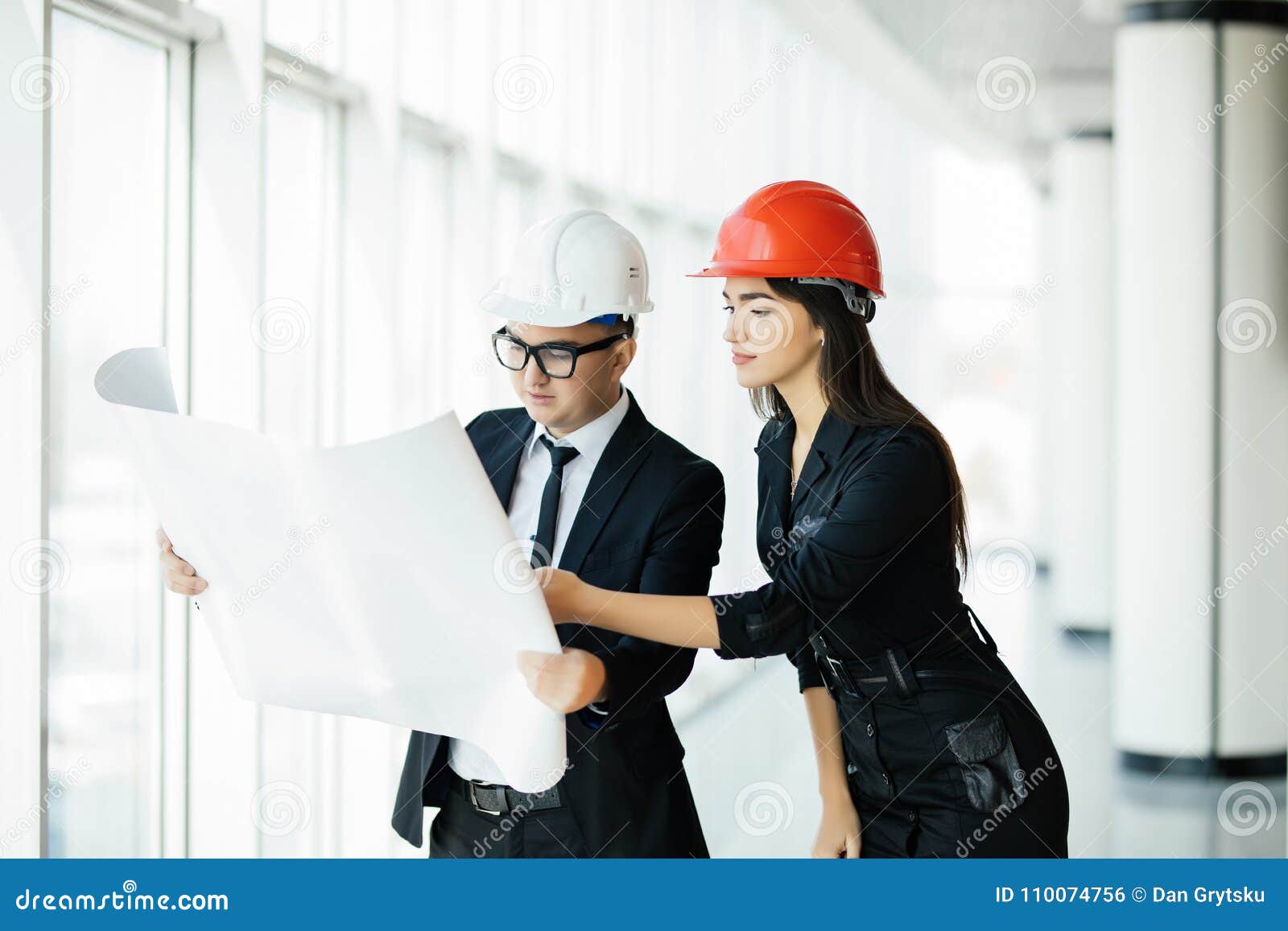 The Two Engineers Stand Near the Panoramic Window and Gesture on ...
