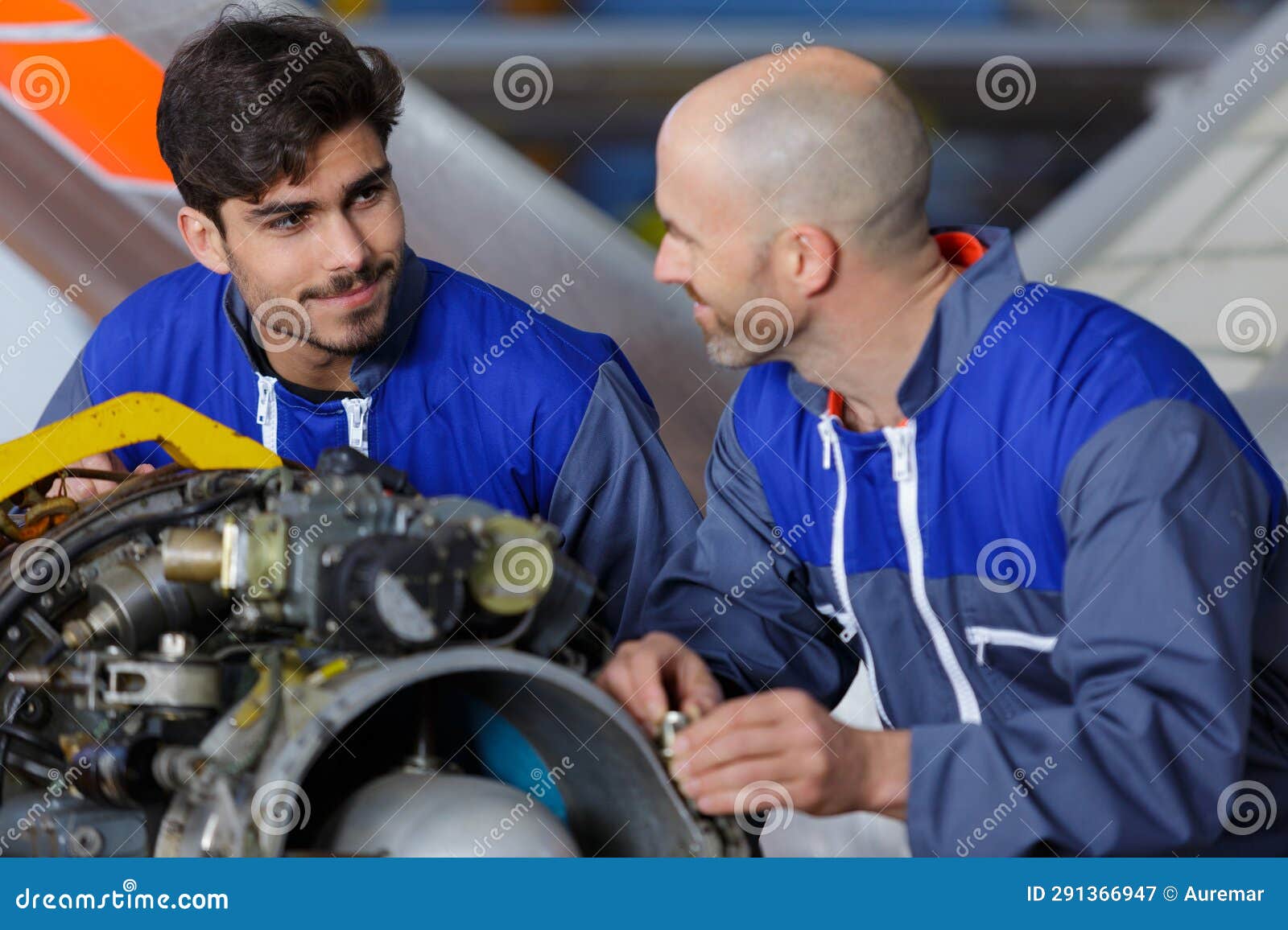 Two Engineers Talking while Working in Hangar Stock Image - Image of ...