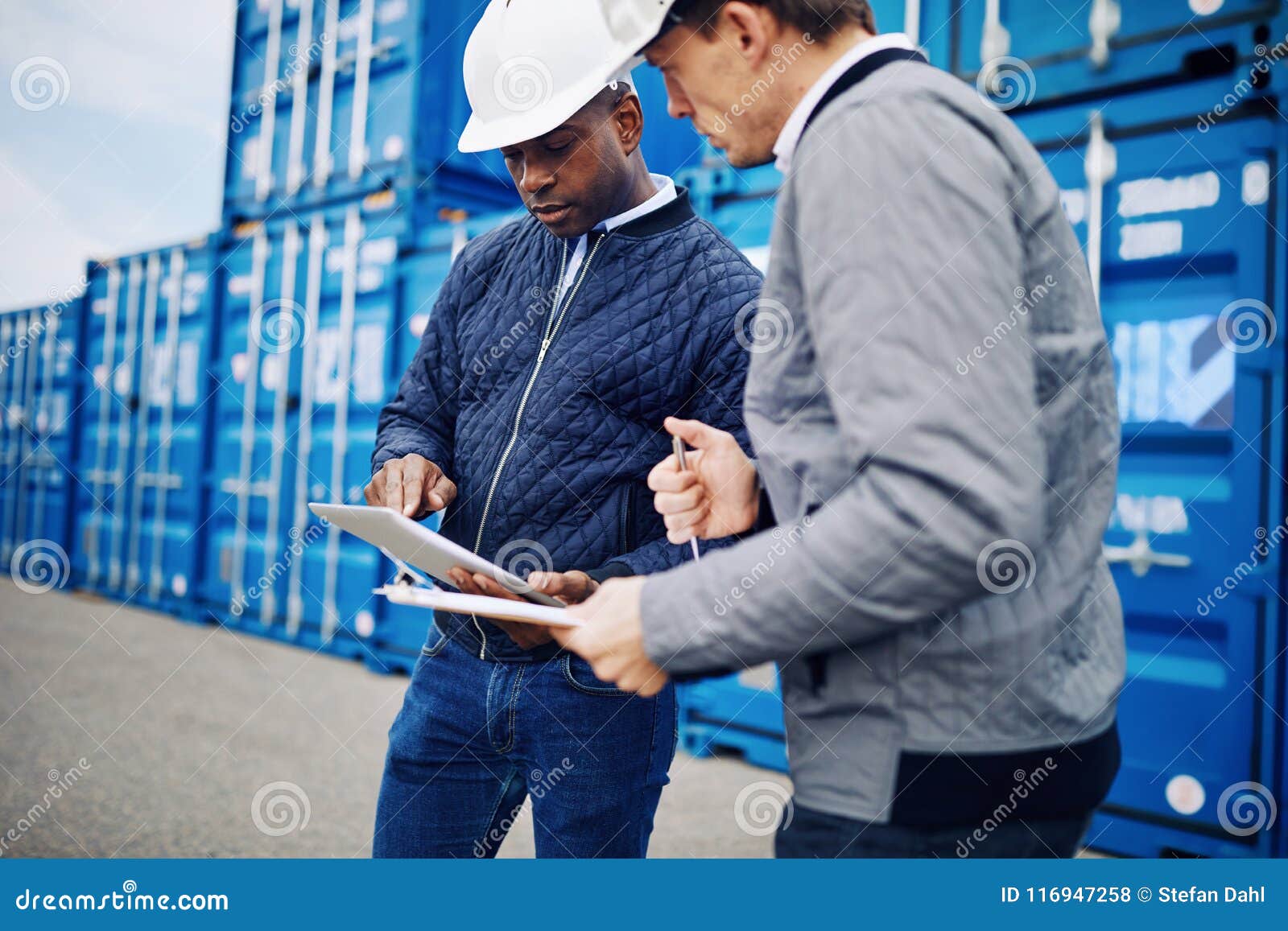 Two Engineers Tracking Freight Together on a Shipping Dock Stock Photo ...