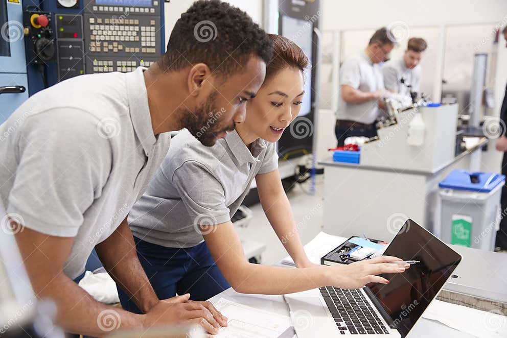 Two Engineers Using CAD Programming Software on Laptop Stock Photo ...