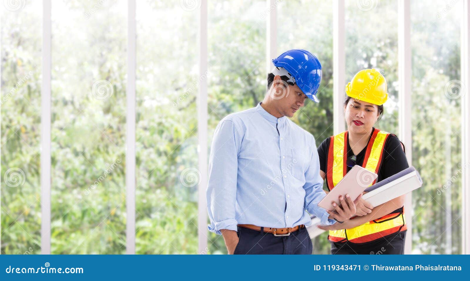 Two Engineers Working Outside with a Tablet. Two Workers are Watching ... Two Engineers Working Outside with a Tablet. Two Workers are Watching ...