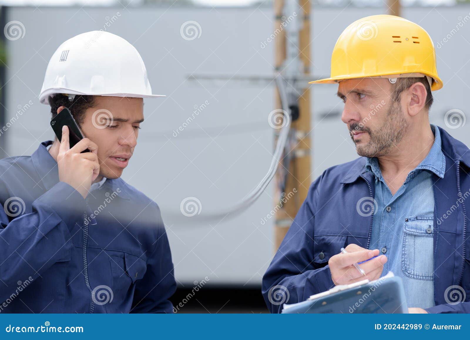 Two Engineers Working Together Outdoors Stock Image - Image of ...