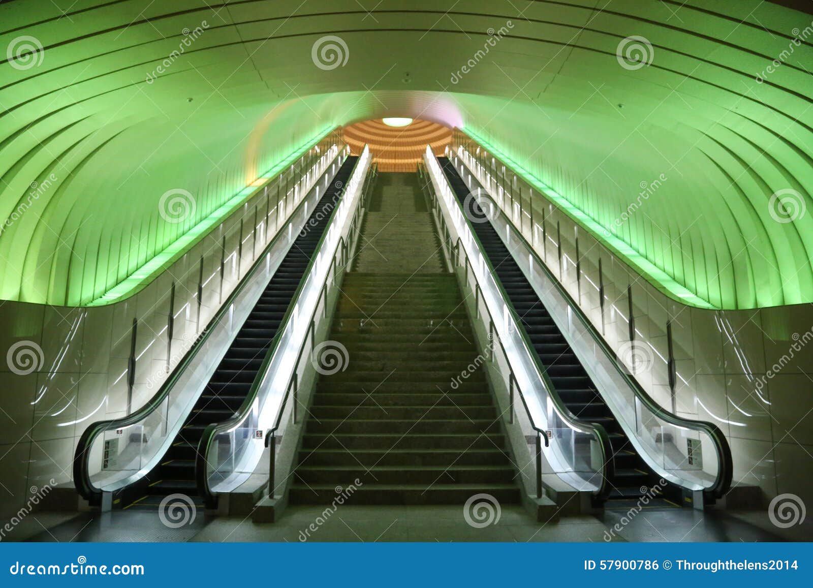 Two Escalators with Green Light Overhead Stock Photo - Image of stairs ...