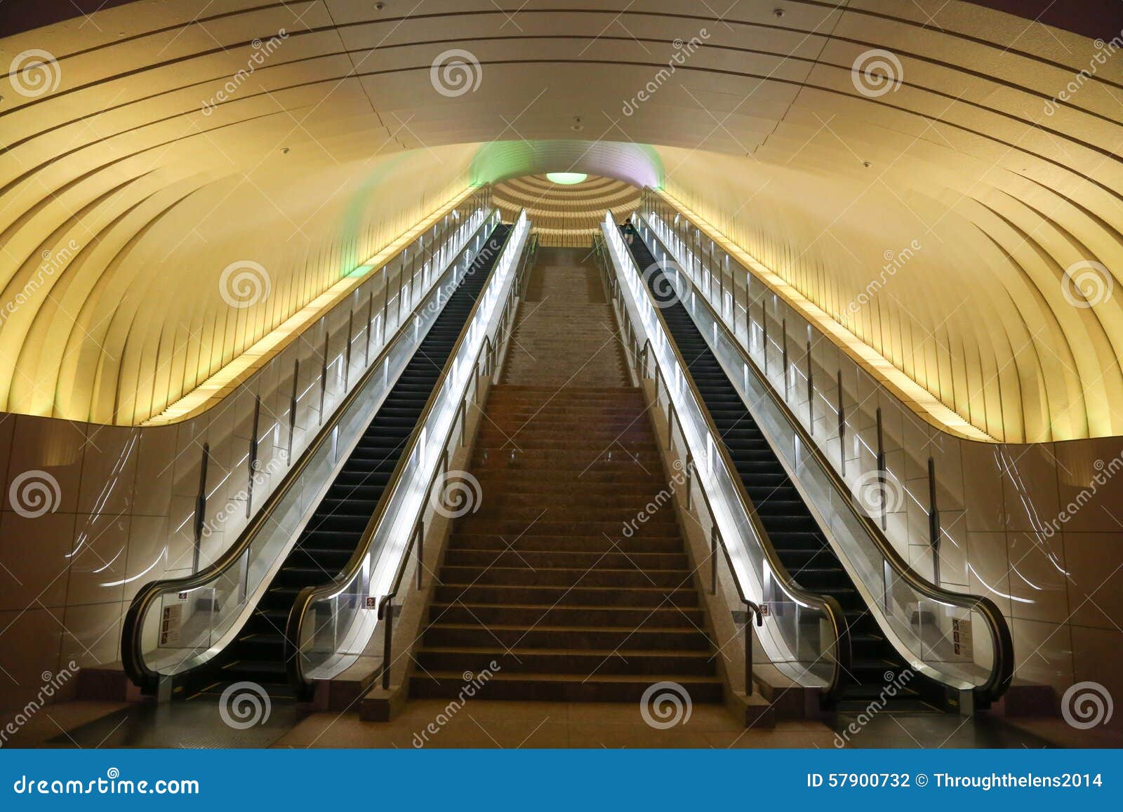 Two Escalators with Yellow Light Overhead Stock Photo - Image of city ...