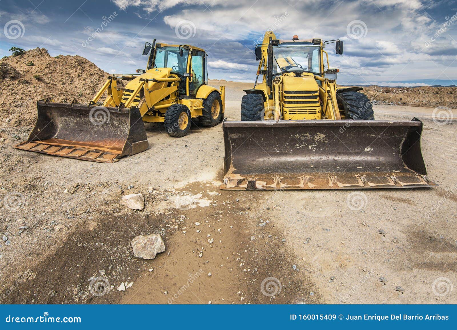 Two Excavators Moving Stone and Rock in a Construction Site Stock Image ...