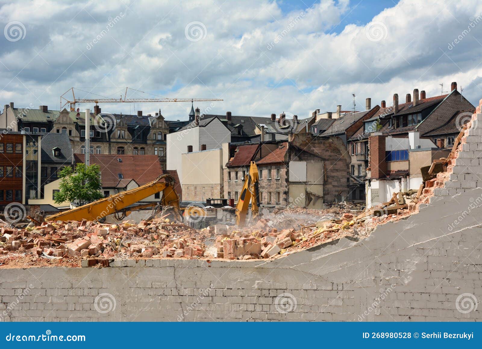Two Excavators are Sorting through the Rubble of Buildings Destroyed ...