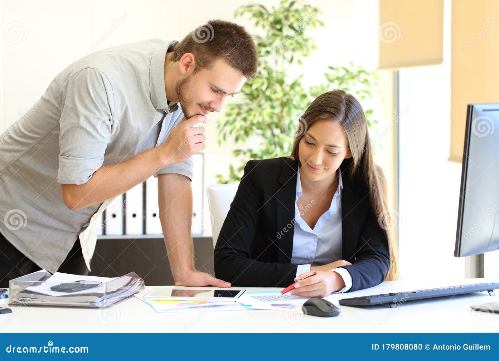 Two Executives Looking at Graph Reports in the Office Stock Photo ...