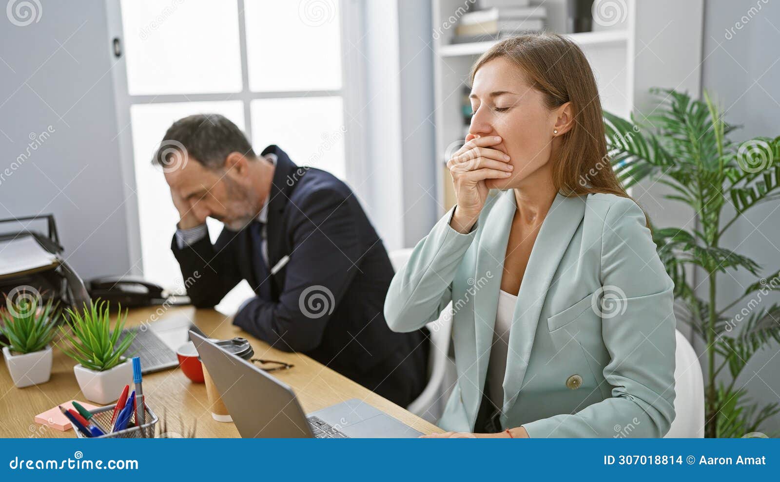 Two Exhausted Business Workers Yawning Together, Signifying Long Hours ...