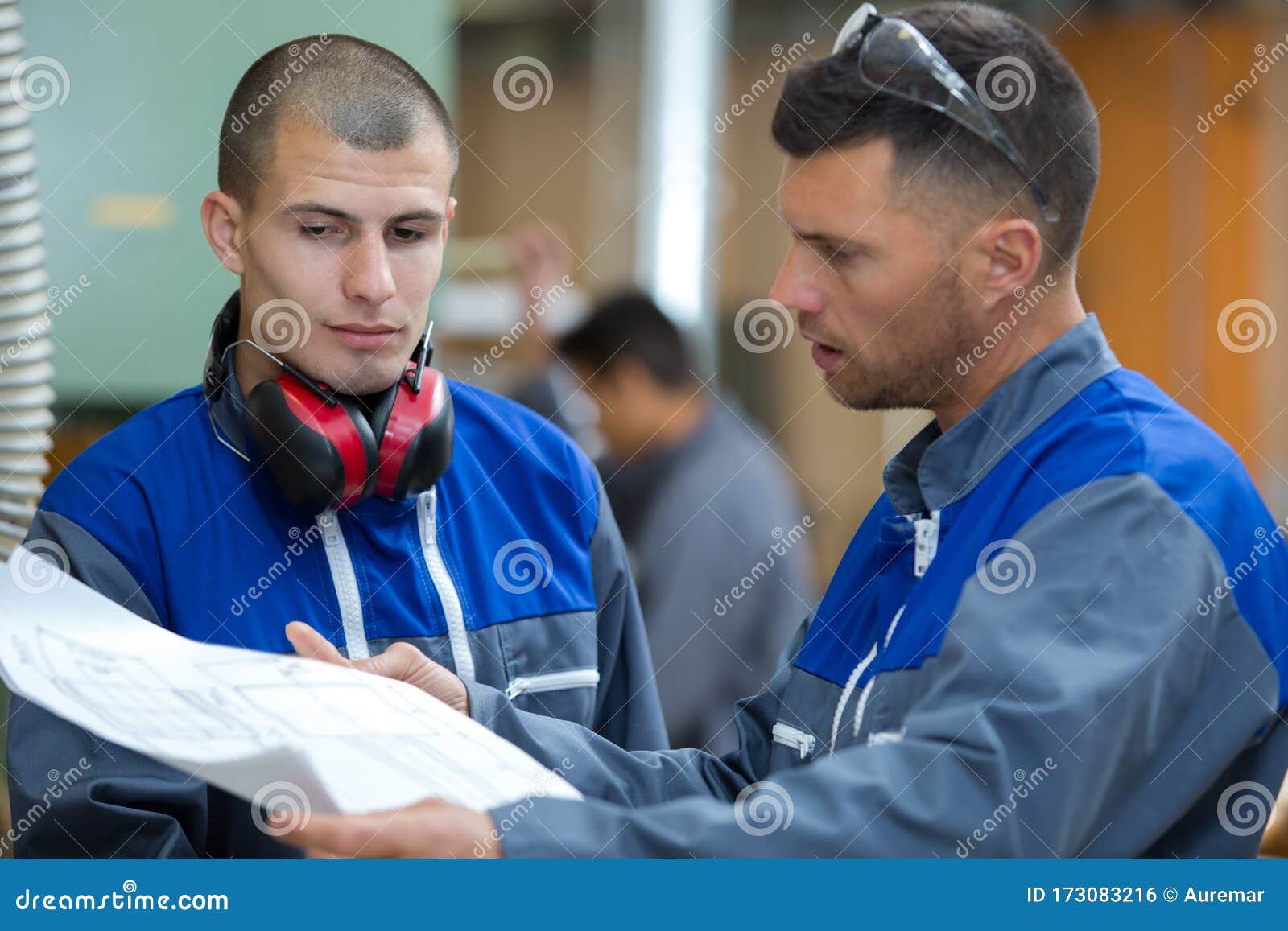 Two Experts Talking while Supervising Plans Stock Photo - Image of ...