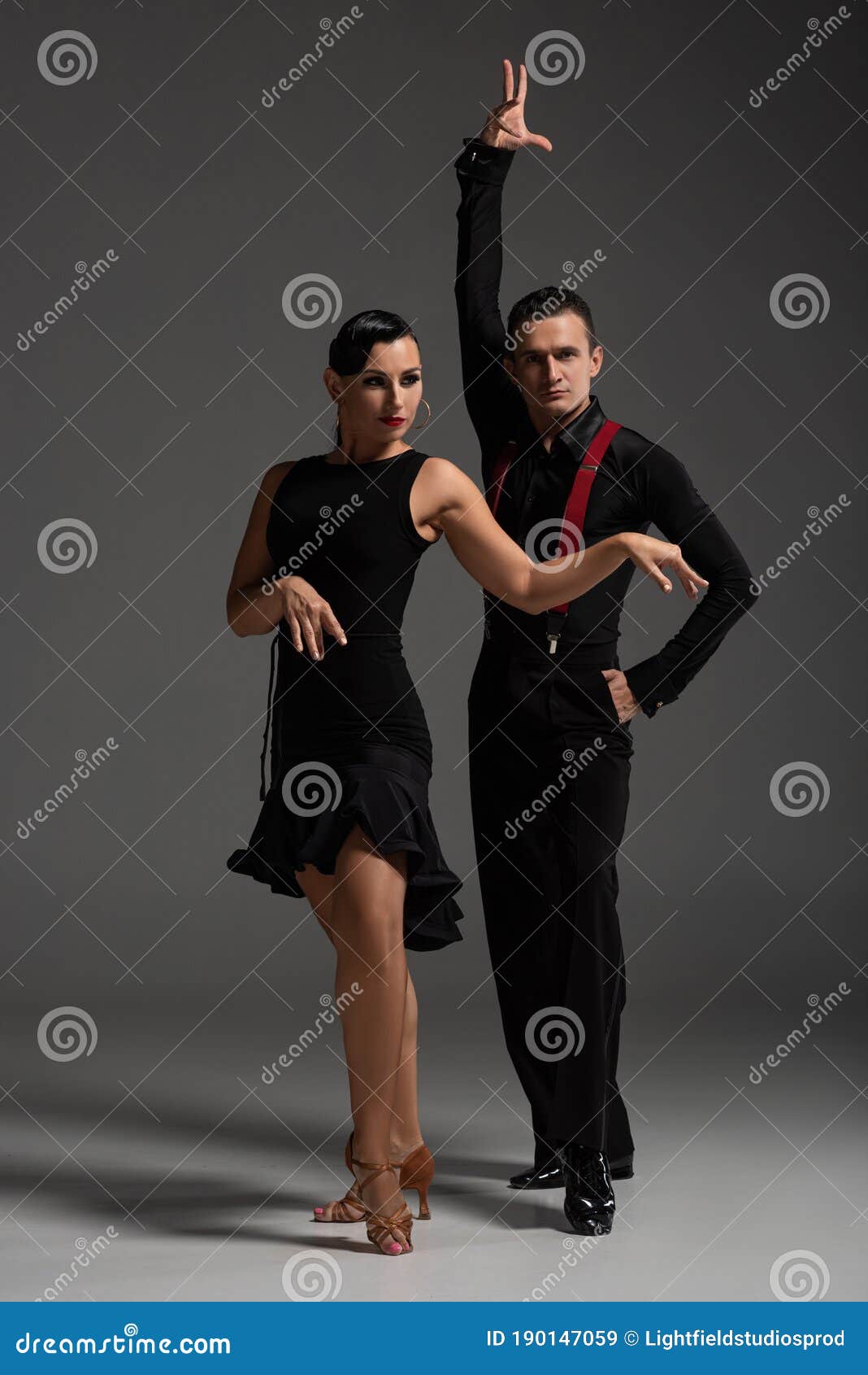 Expressive Dancers in Black Clothing Performing Tango on Grey ...