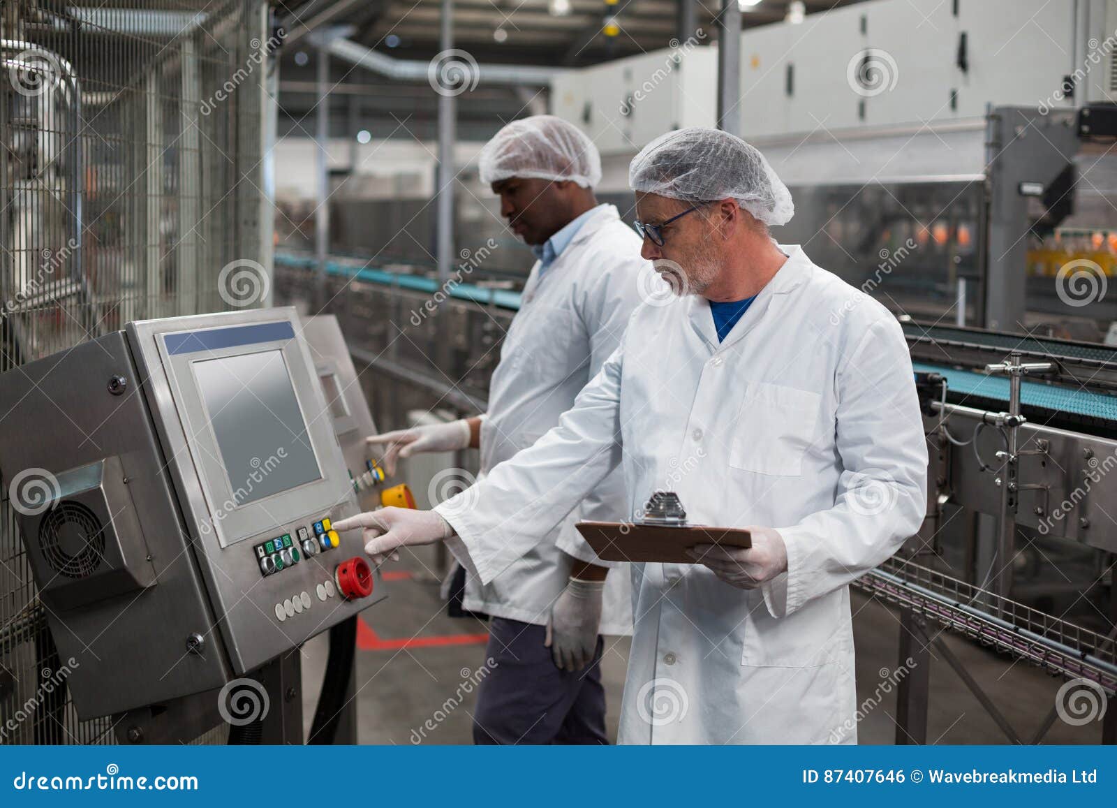 Two Factory Engineers Operating Machine in Factory Stock Photo - Image ...