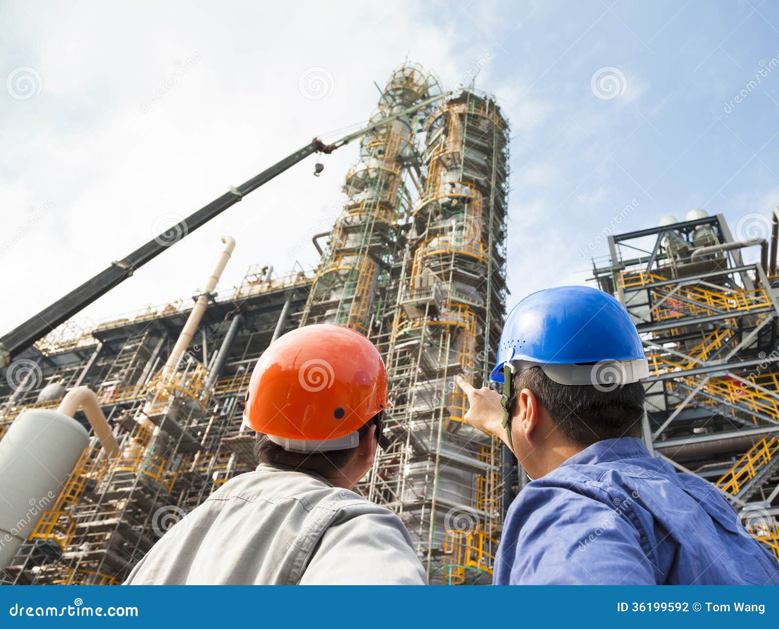 Two Factory Workers Discussion and Pointing for in Stock Photo - Image ...