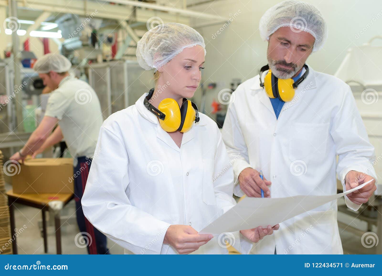 Two Factory Workers Looking at Paperwork Stock Image - Image of women ... Two Factory Workers Looking at Paperwork Stock Image - Image of women ...