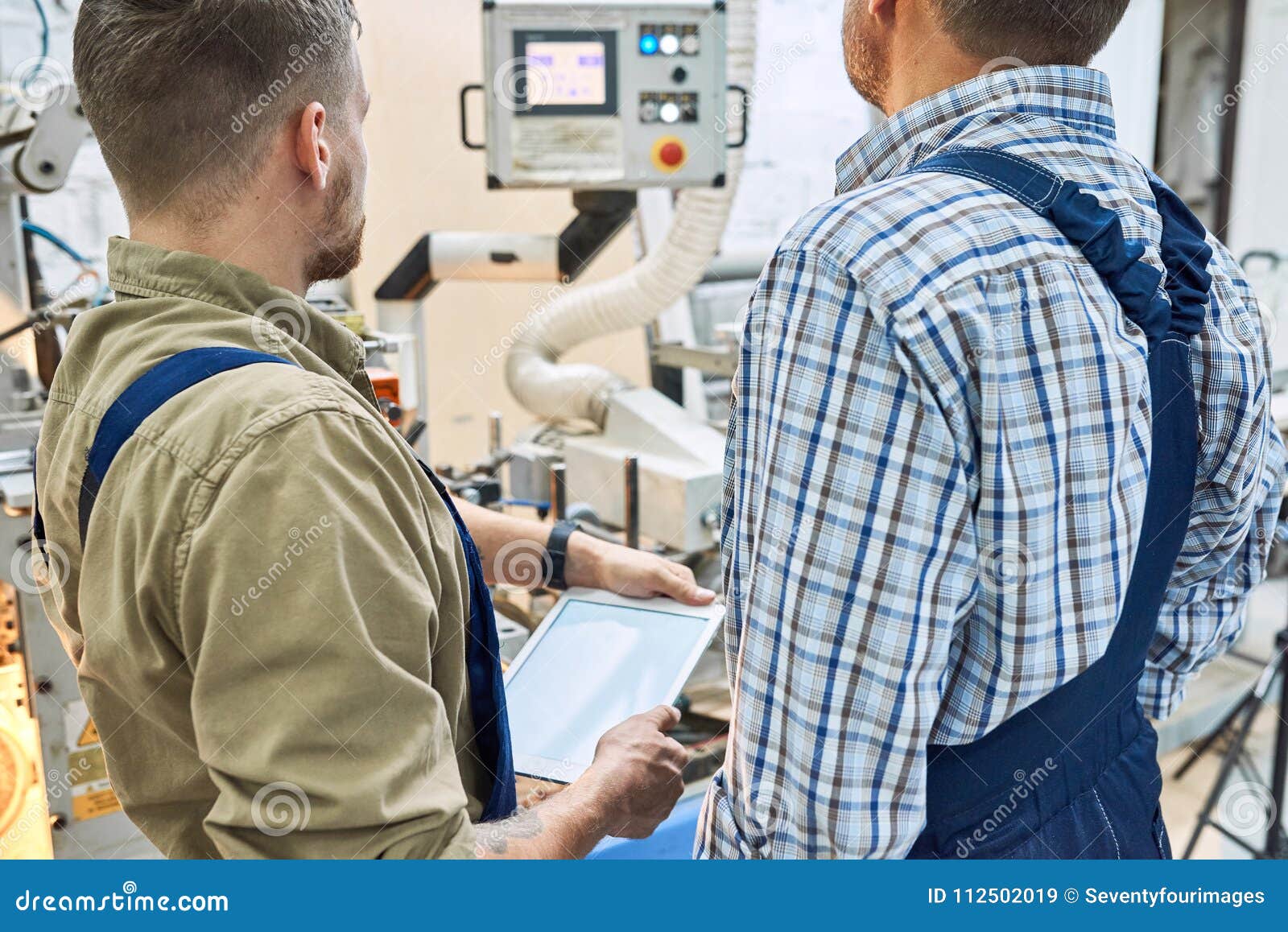 Two Factory Workers Operating Machine Units Stock Image - Image of ...