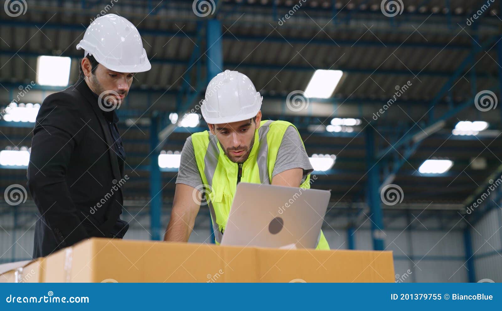 Two Factory Workers Working and Discussing Manufacturing Plan in the ...