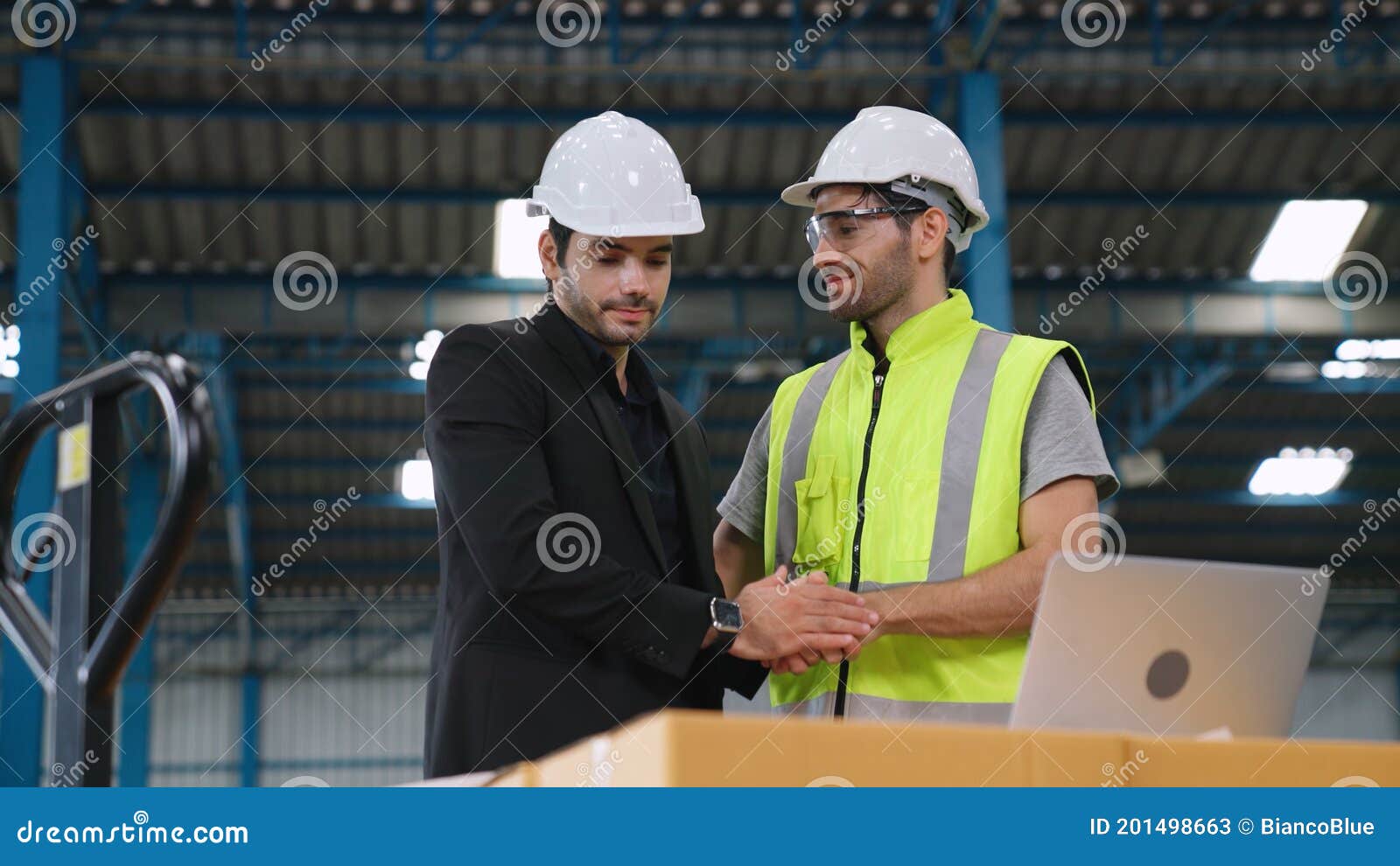 Two Factory Workers Working and Discussing Manufacturing Plan in the ...